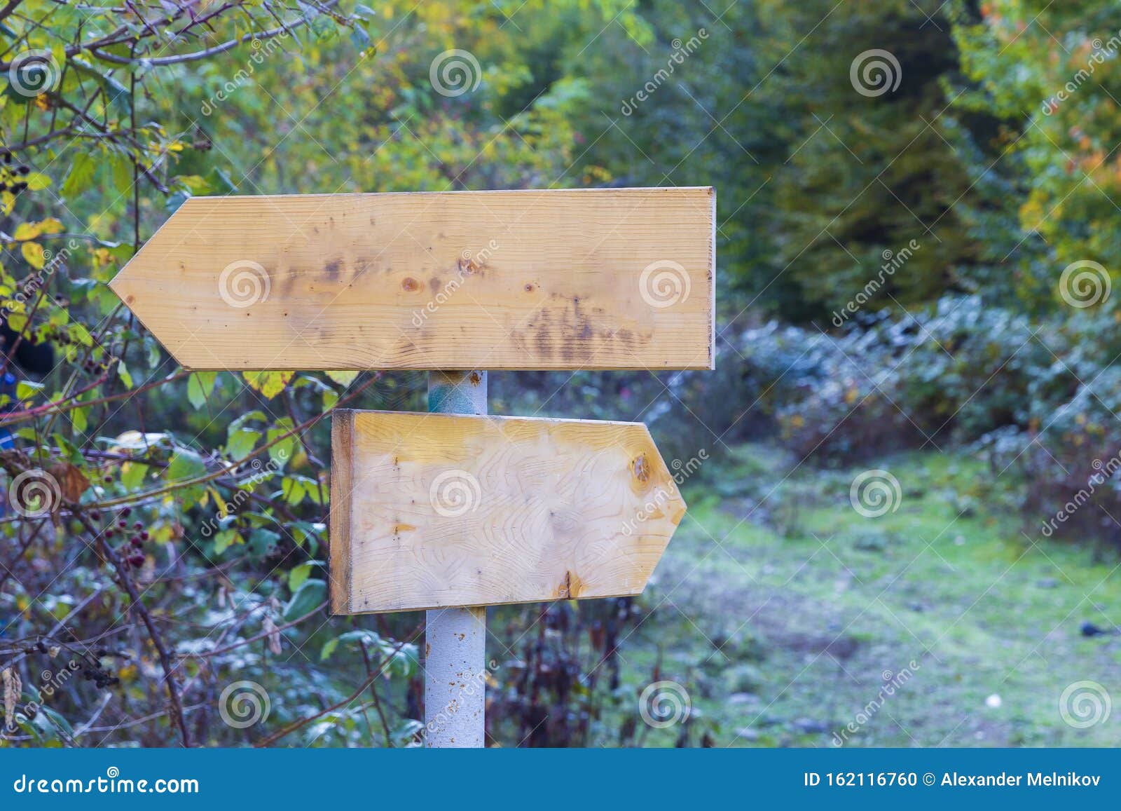 Wooden Arrow Direction Signs in the Forest on a Pillar Stock Photo ...