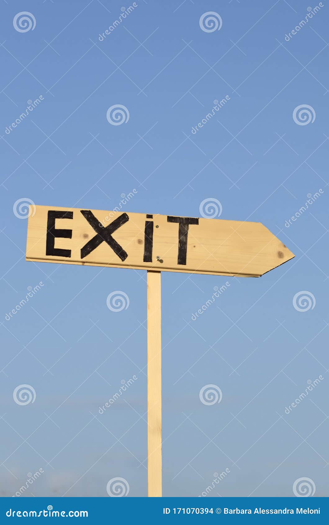 Wooden Arrow Sign with the Word Exit. in the Background the Blue Sky ...