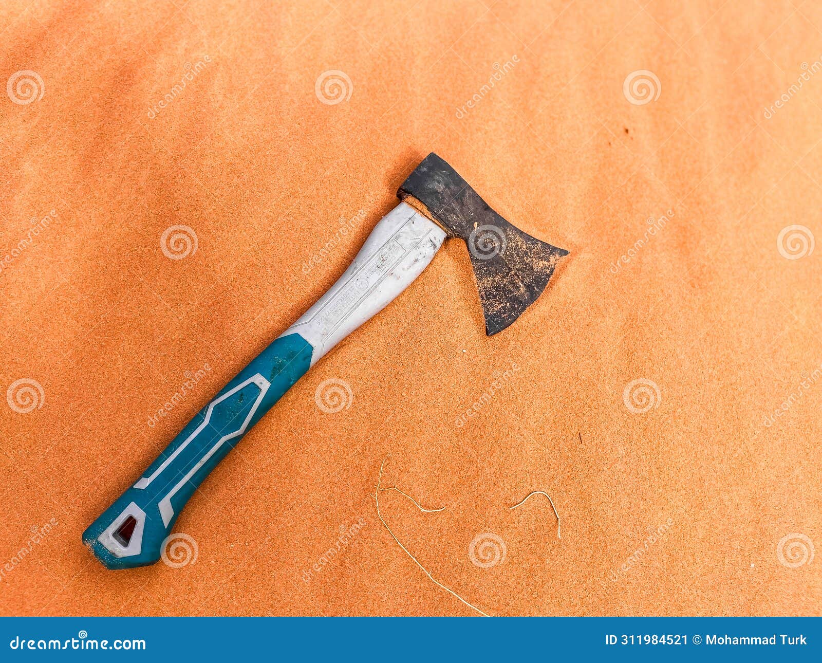 A Wooden Axe Laying on the Sand of a Desert Ground. Tools in Sand Stock ...