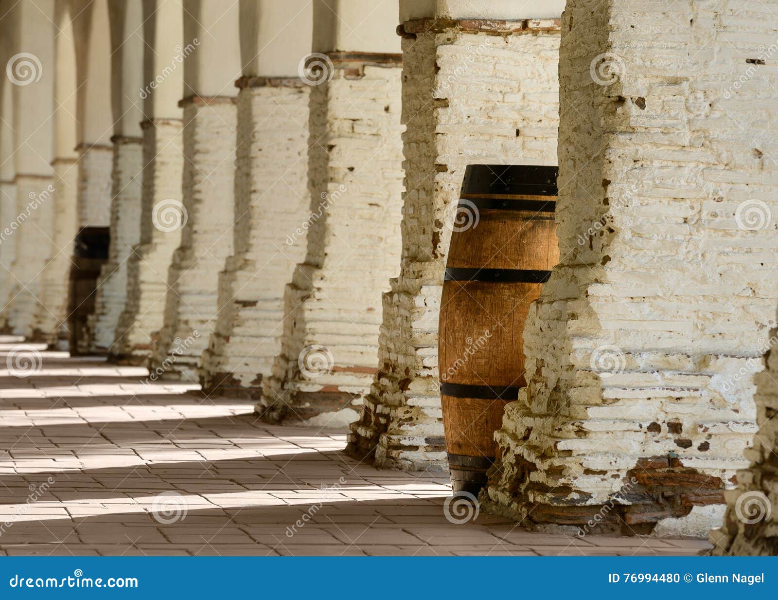 Wooden Barrel Under Repeating Arches Stock Photo - Image of shadows ...