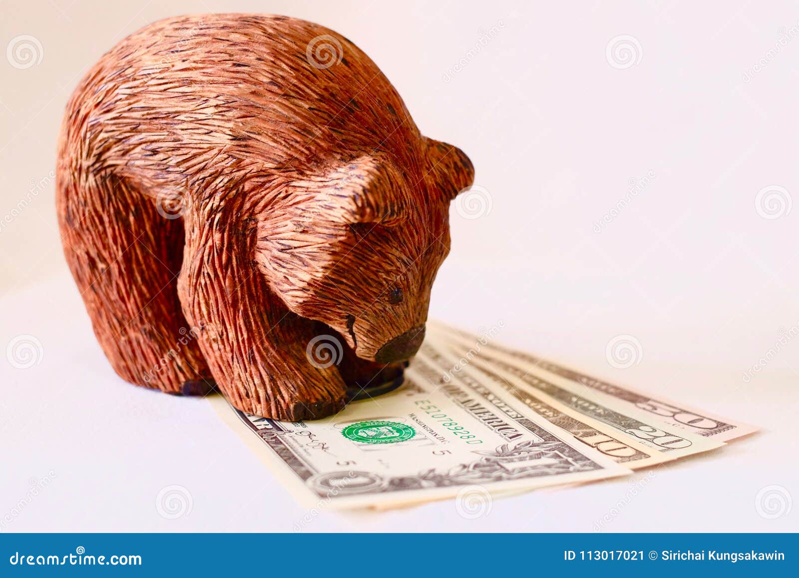 Wooden bear on dollars stock image. Image of monetary - 113017021