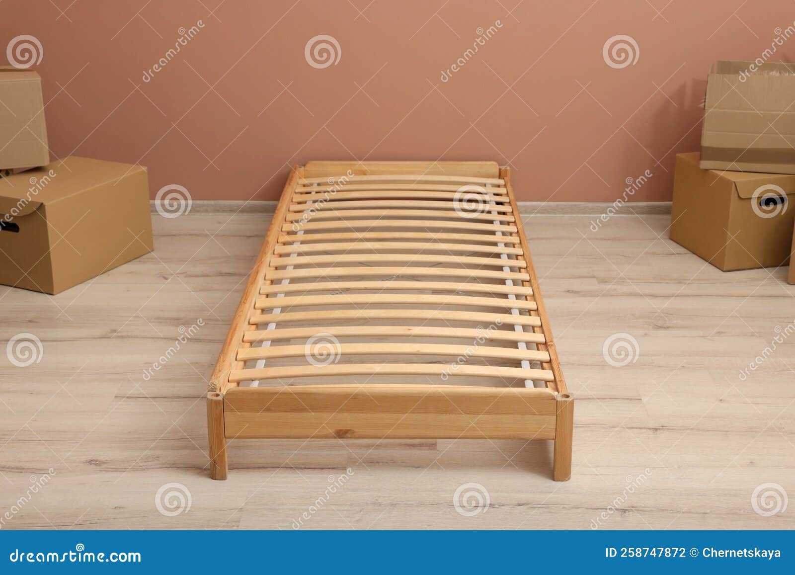 Wooden Bed Frame and Cardboard Boxes on Floor in Room Stock Photo ...