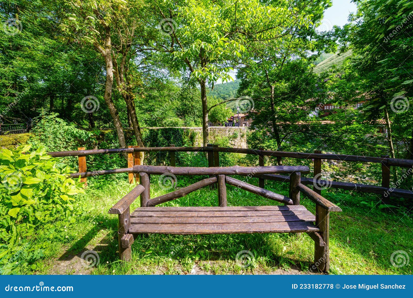 Wooden Bench in a Park Next To a Mountain Stream Stock Photo - Image of ...