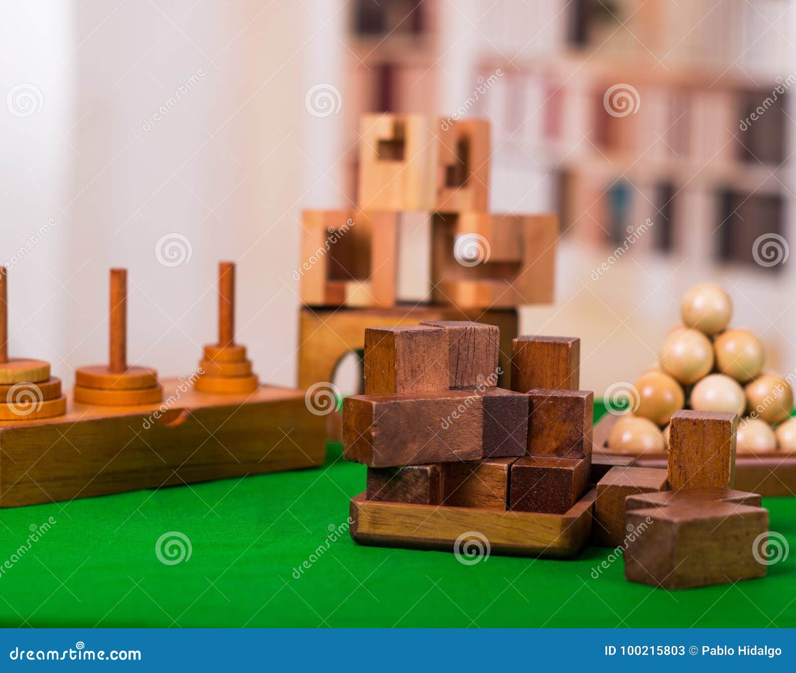 Wooden Block Brain Teaser Puzzle on Green Table in a Blurred Background ...