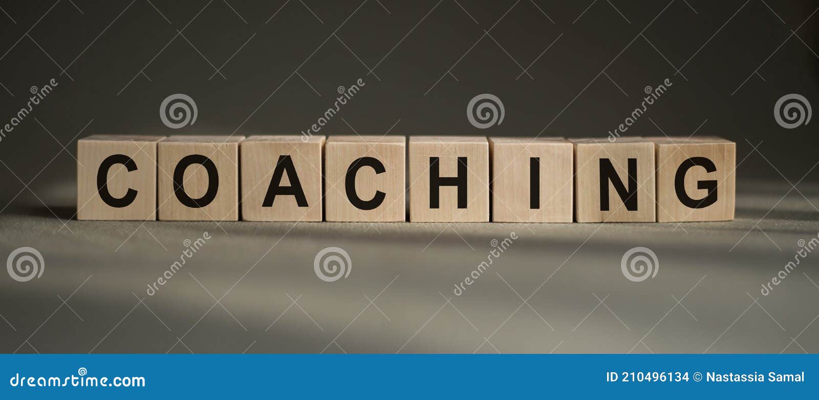 A Wooden Blocks with the Word Coaching Written on it on a Gray ...