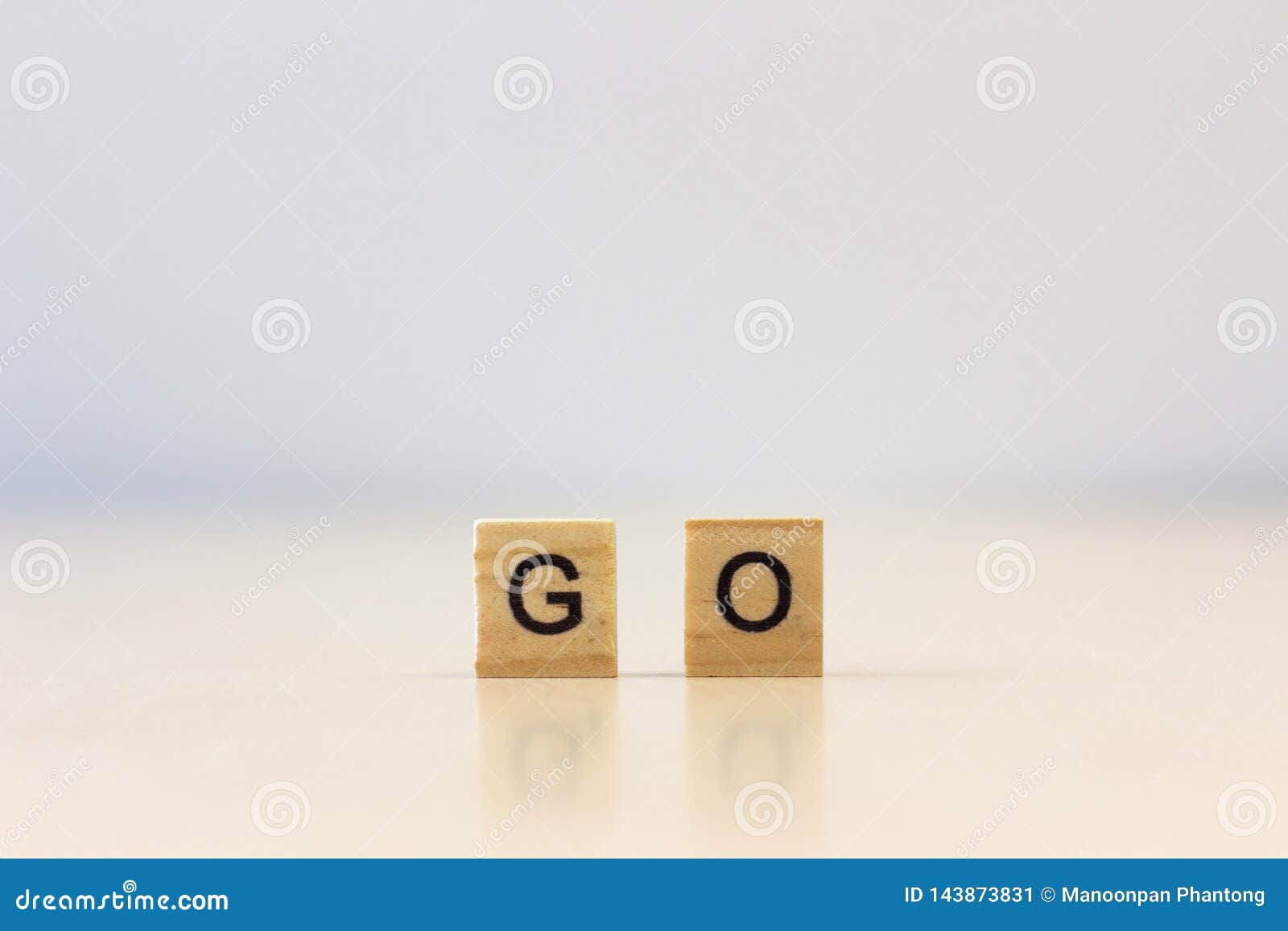 Wooden blocks word `GO` stock image. Image of isolated - 143873831