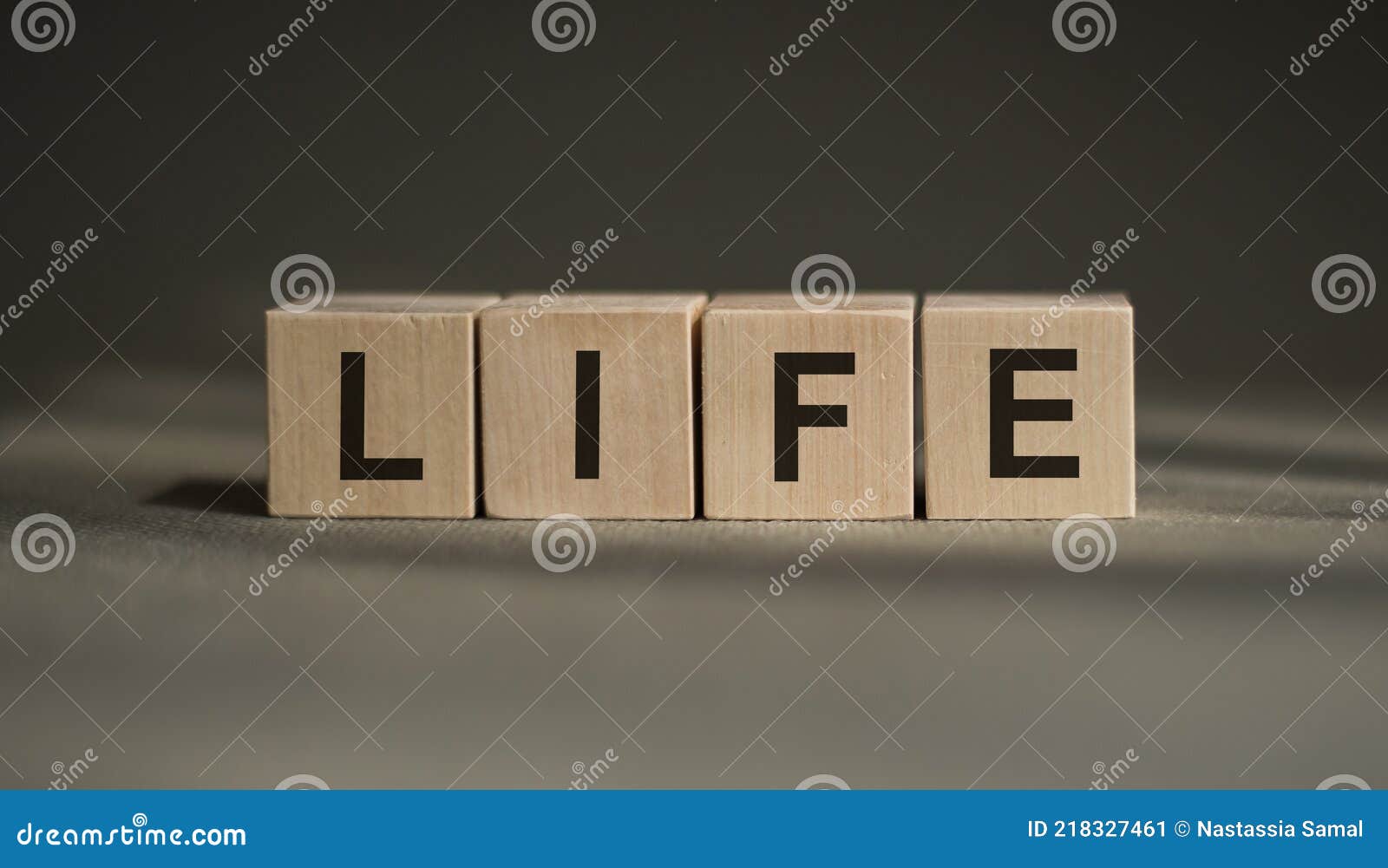 A Wooden Blocks with the Word LIFE Written on it on a Gray Background ...