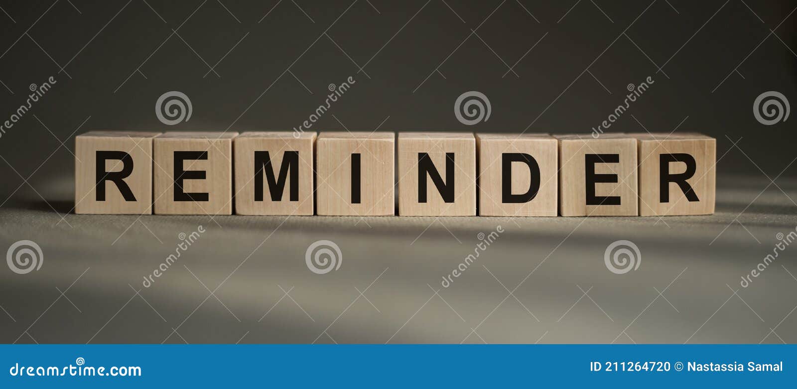 A Wooden Blocks with the Word REMINDER Written on it on a Gray ...