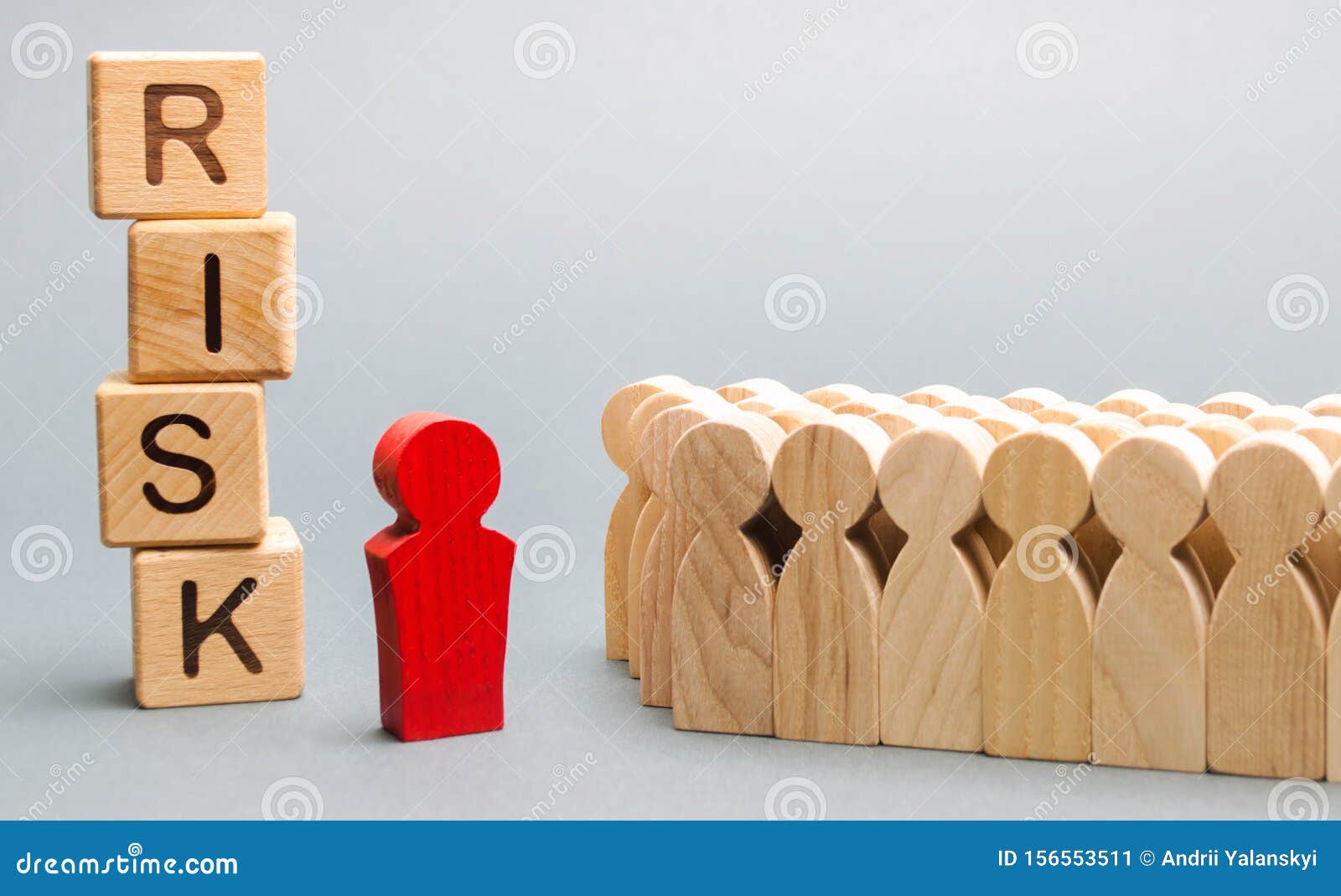 Wooden Blocks with the Word Risk and a Team with a Leader. Business ...