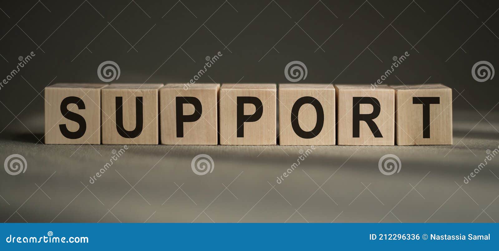 A Wooden Blocks with the Word SUPPORT Written on it on a Gray ...
