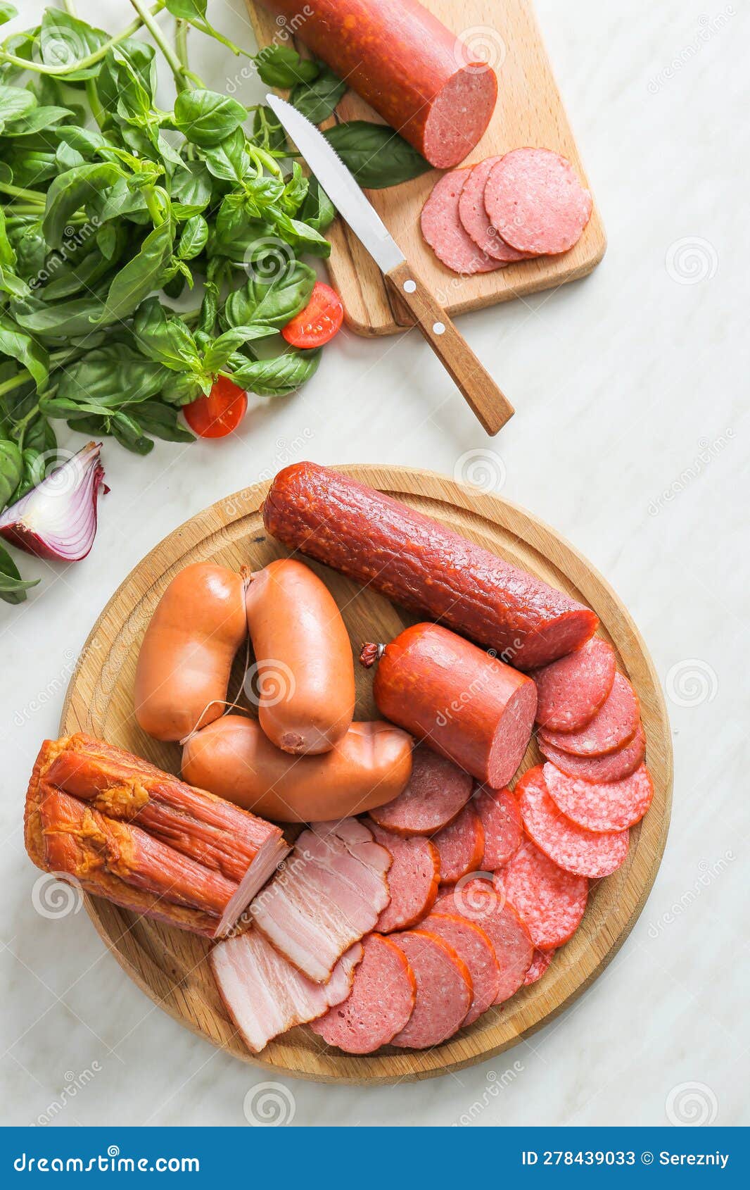 Wooden Board with Assortment of Sausages on Light Table Stock Image ...