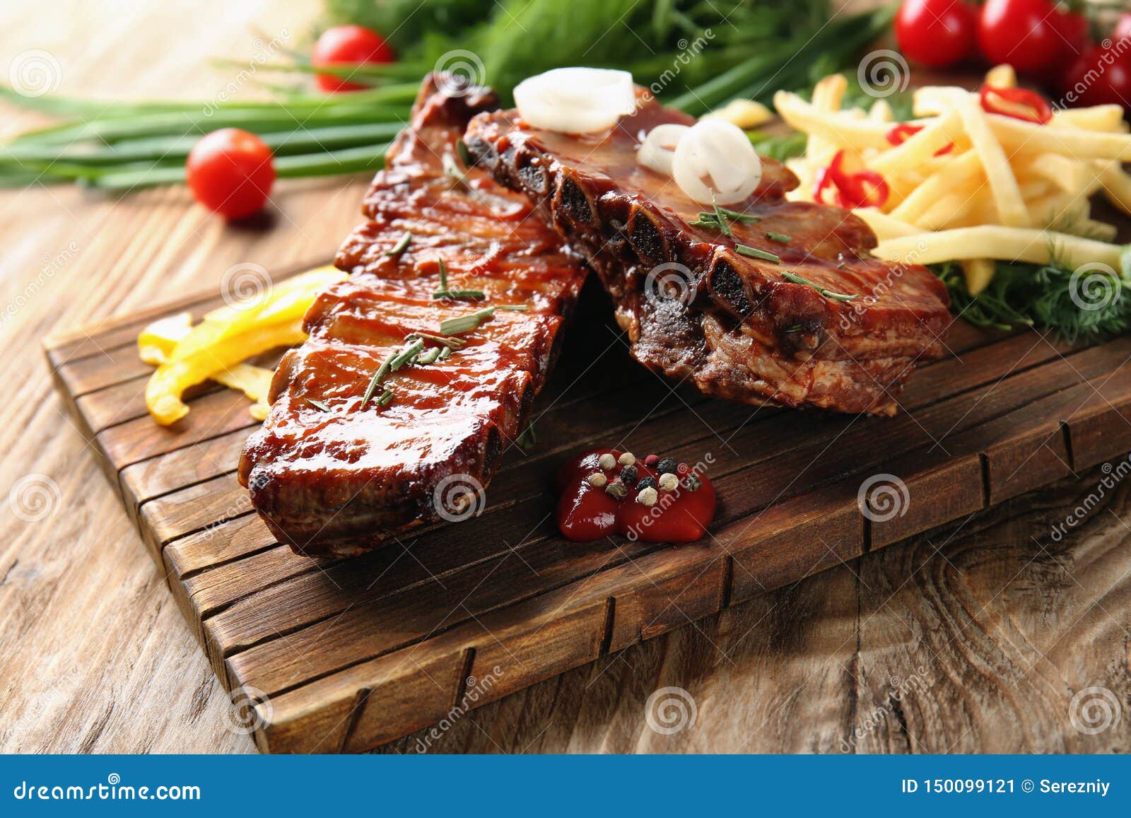 Wooden Board with Delicious Grilled Ribs on Table Stock Image - Image ...