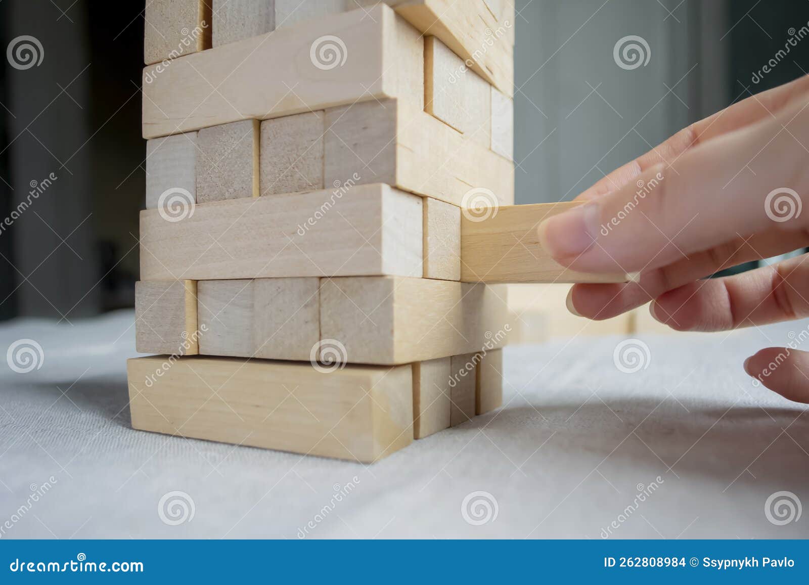 Wooden Board Game Tower. a Hand Pulls Out an Element from the Wooden ...
