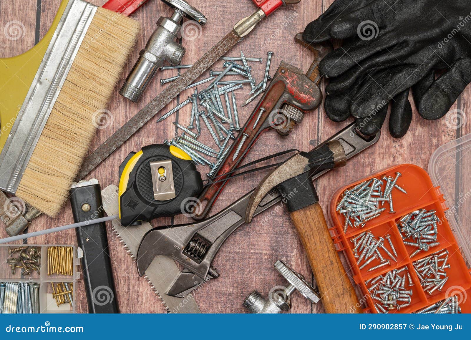 On a Wooden Board, a Variety of Tools Needed for Home Repair are ...
