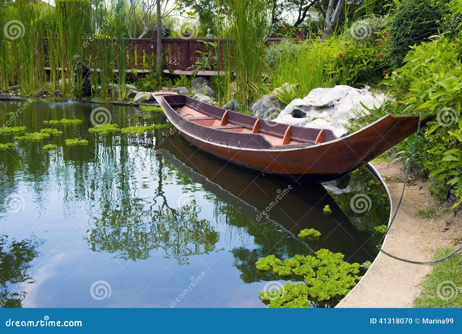 Wooden boat in pond stock photo. Image of bloom, plant - 41318070