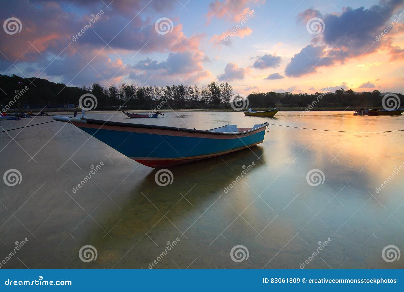 Wooden Boat In Water At Sunset Picture. Image: 83061809