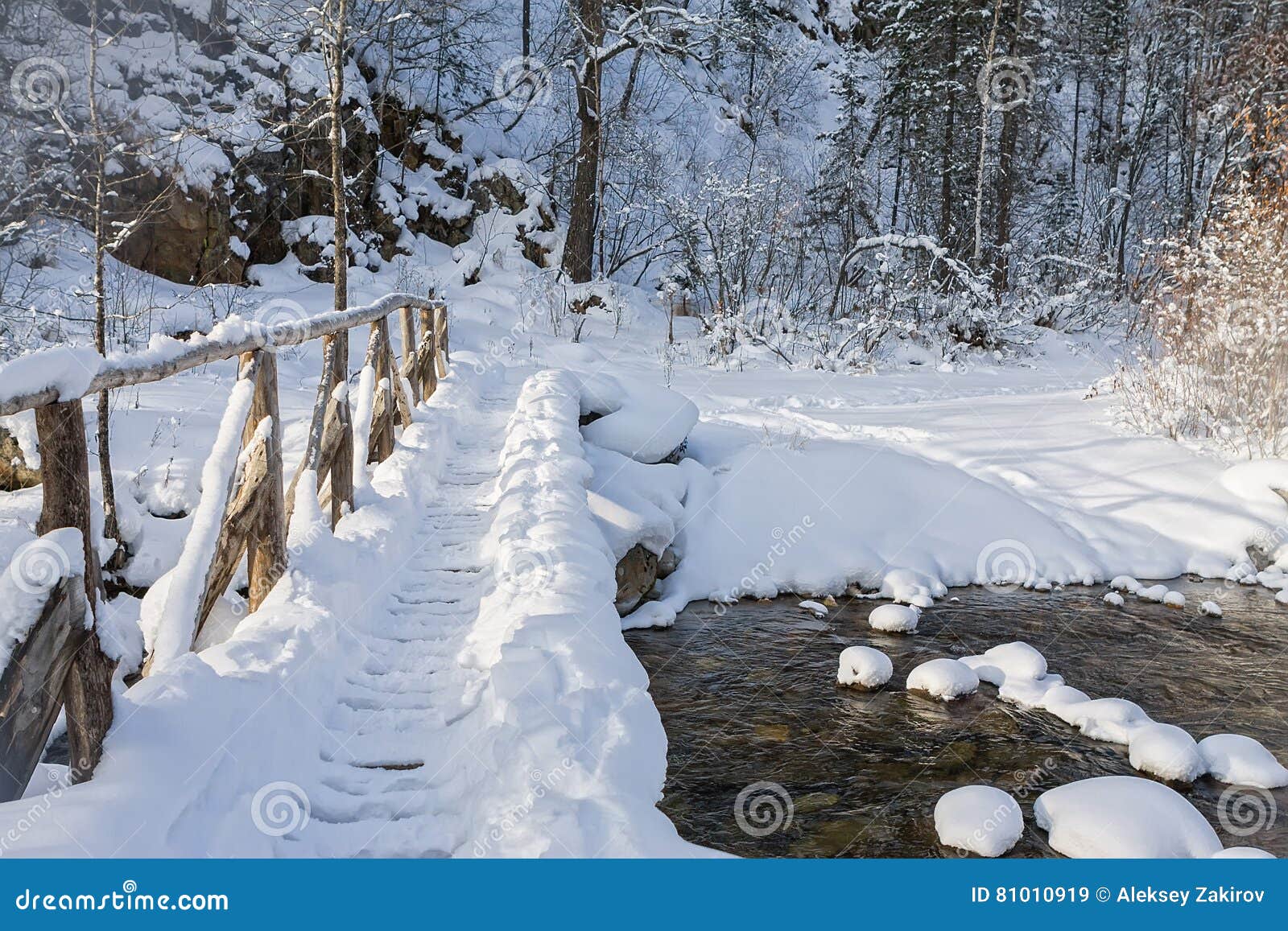 Wooden Bridge Over the River in Snow in Winter Forest Stock Image ...