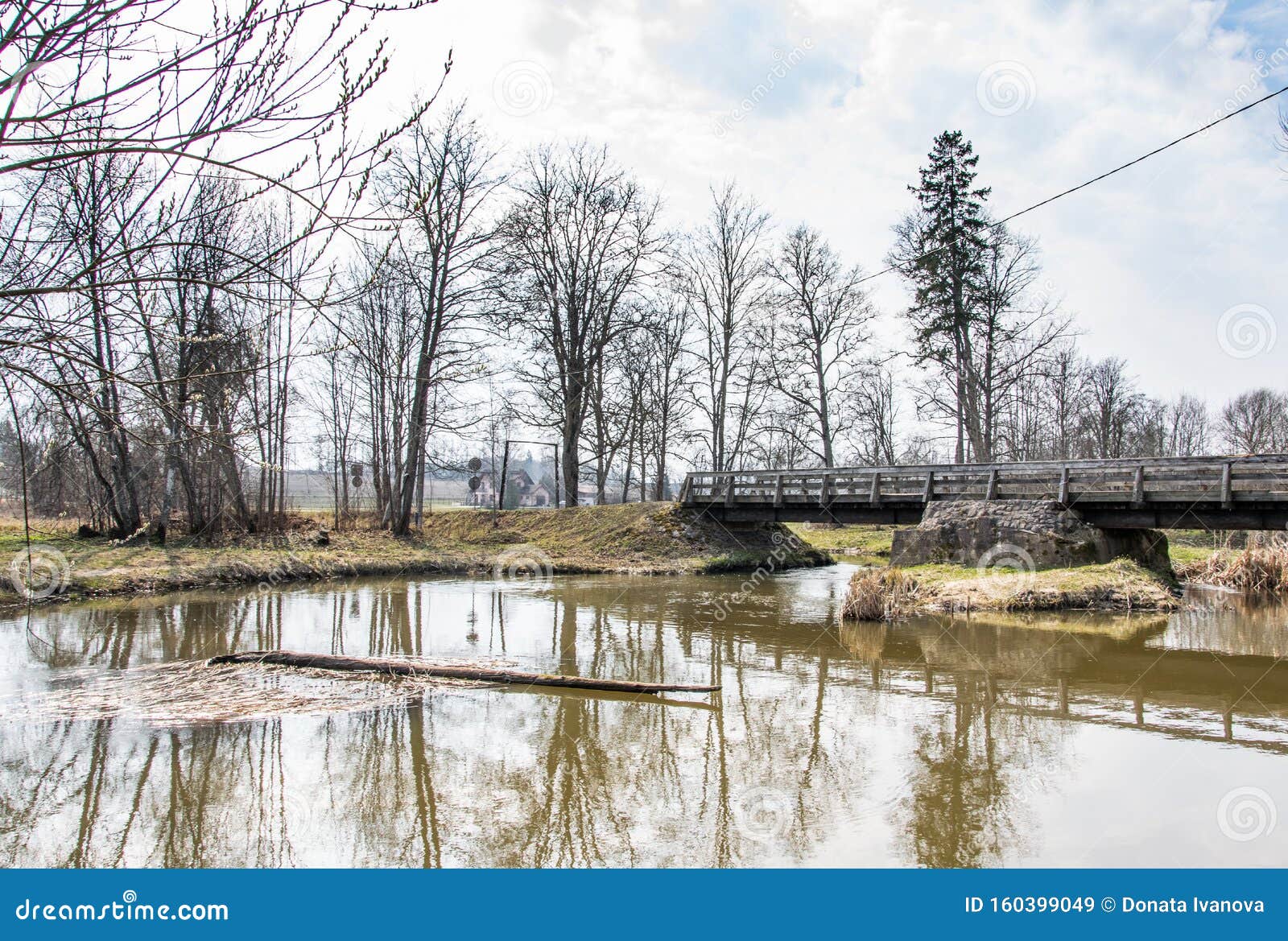 Spring Landscape. a Wooden Bridge Over a Small River in Early Spring ...