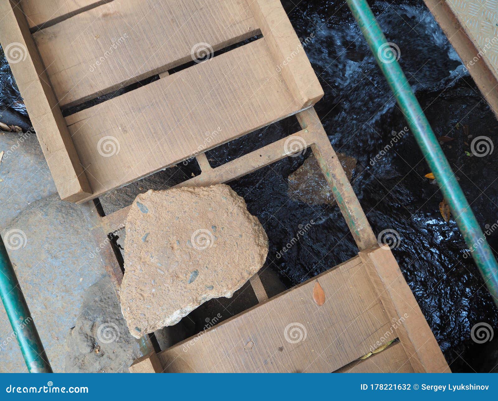 A Wooden Bridge Over a Stream with One Board Broken. Stock Photo ...
