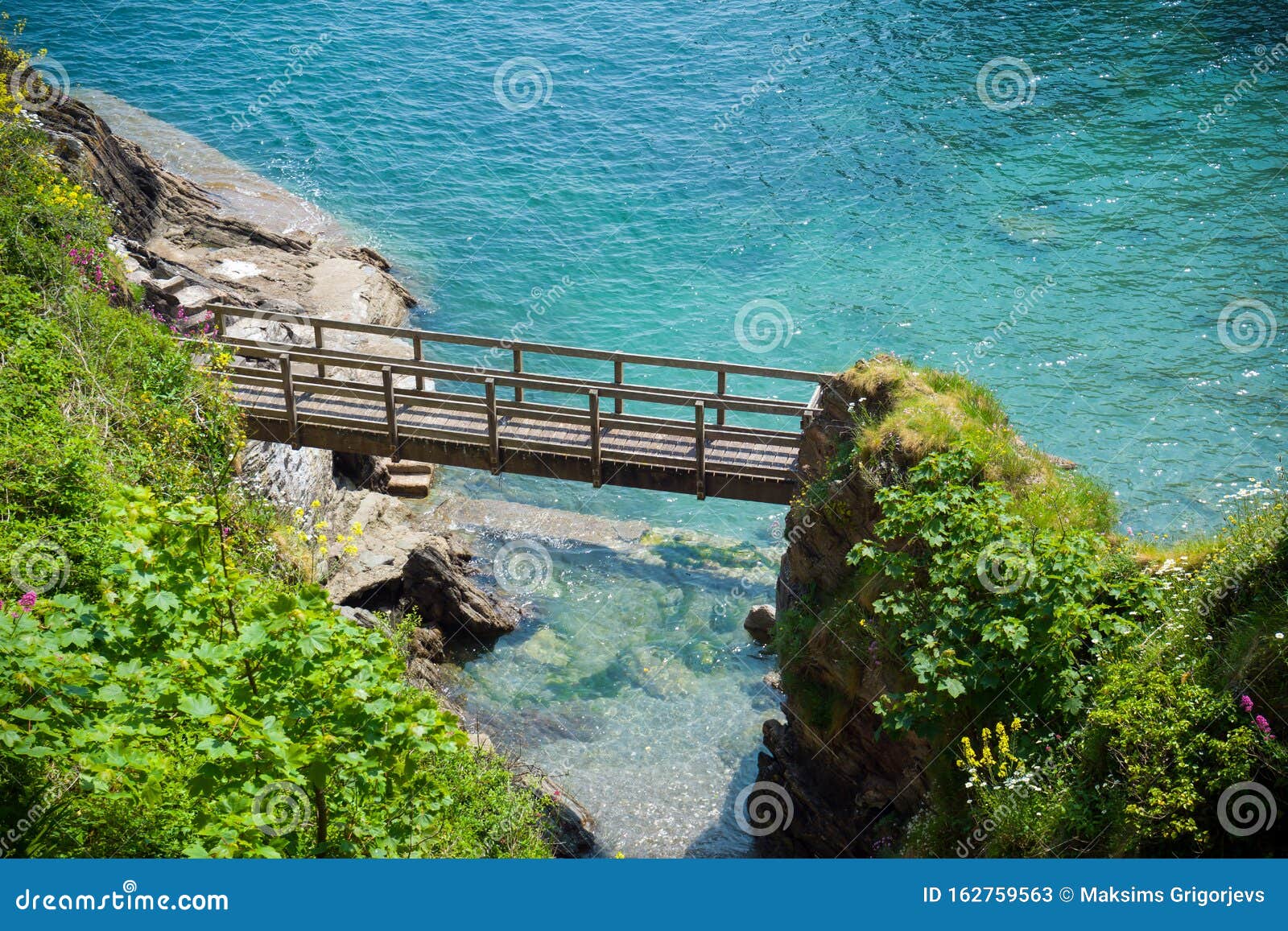 Wooden Bridge between Rocks and Sea. England, Devon Stock Image - Image ...