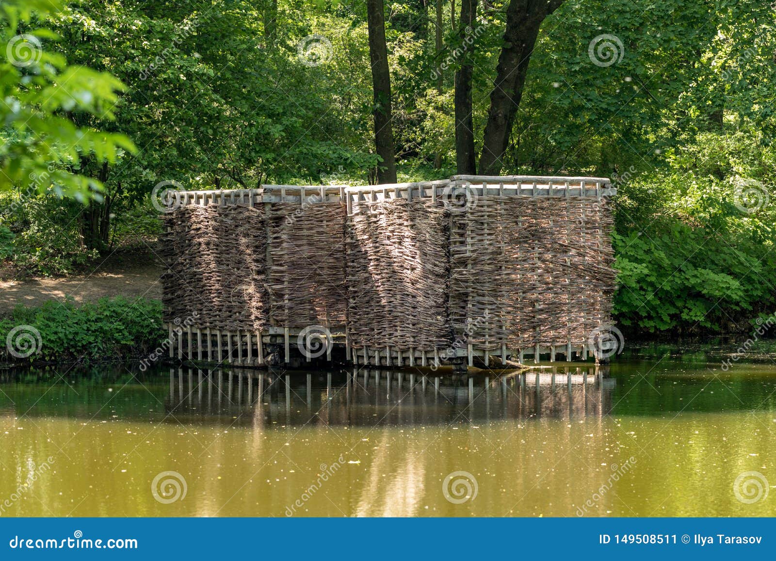 Wooden Building on the Shore of the Pond. Wicker Building in the Forest ...
