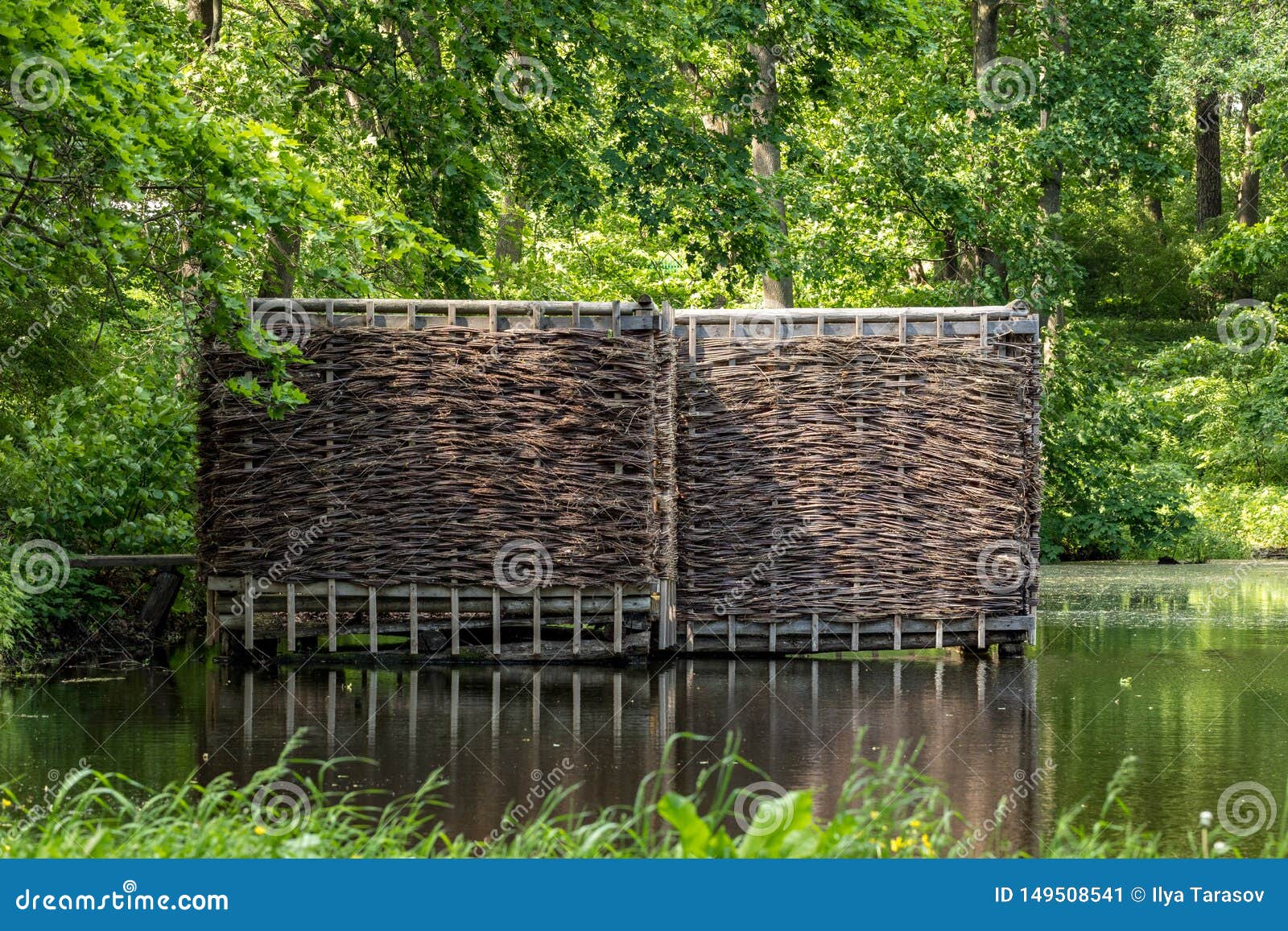 Wooden Building on the Shore of the Pond. Wicker Building in the Forest ...