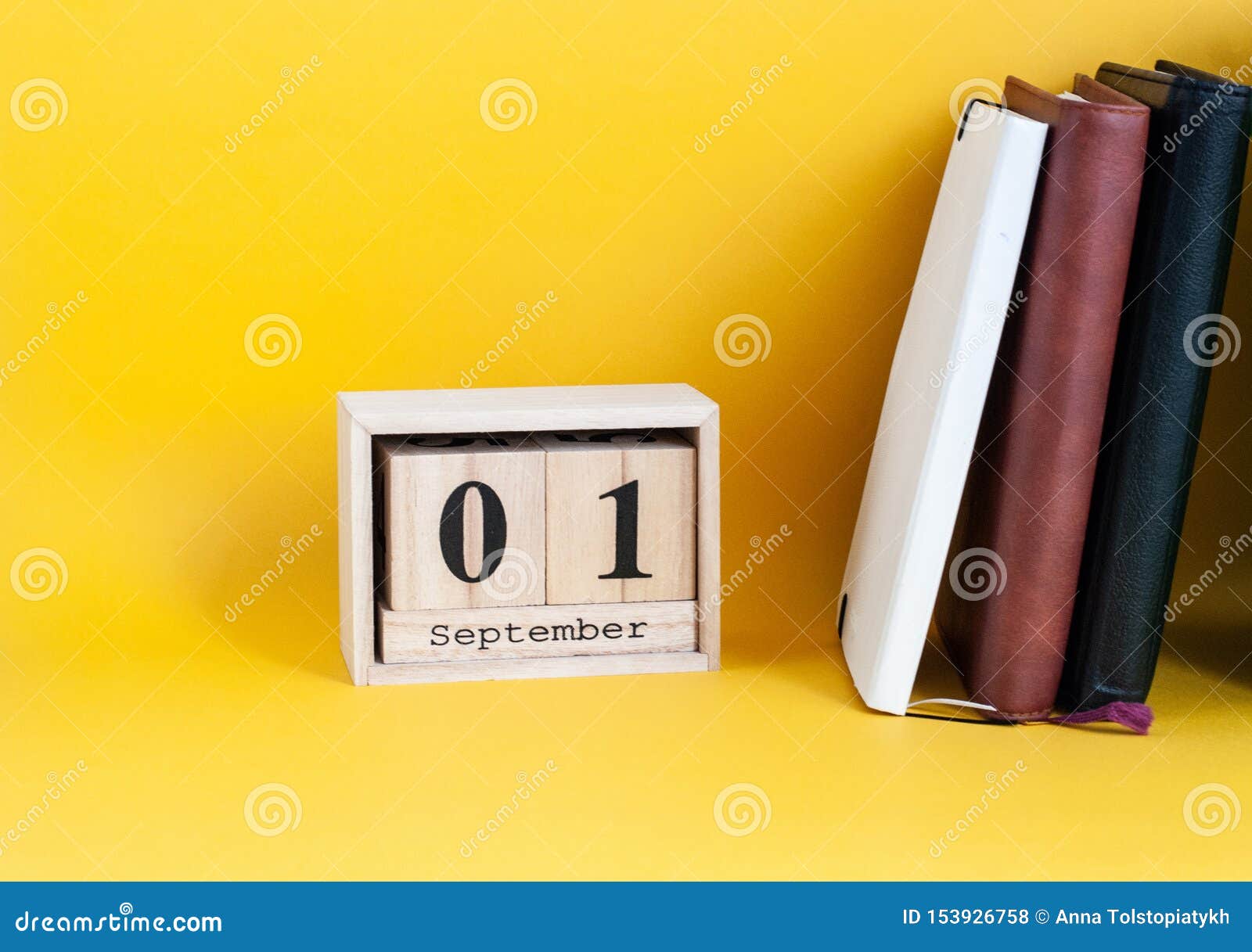 Wooden Calendar with the Date of September 1 Next is a Stack of ...