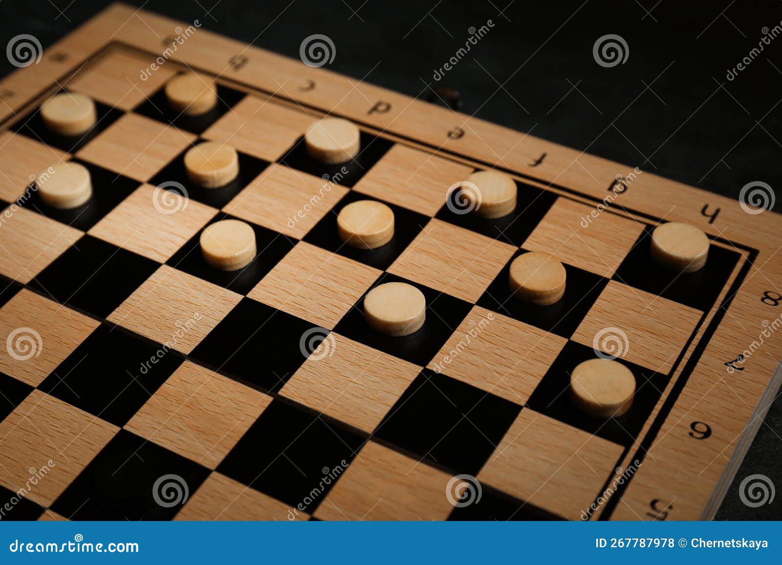 Wooden Checkerboard with Game Pieces on Black Table, Closeup Stock ...