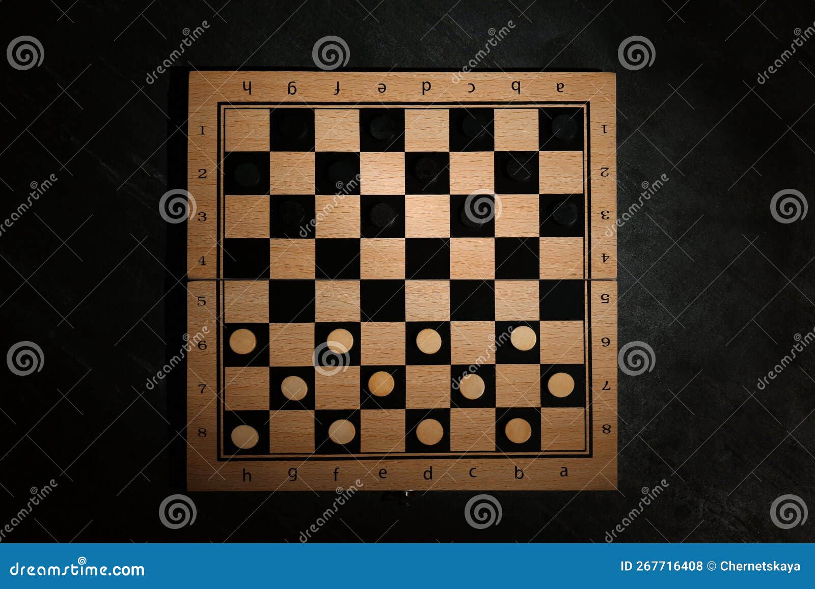 Wooden Checkerboard with Game Pieces on Black Table, Top View Stock ...