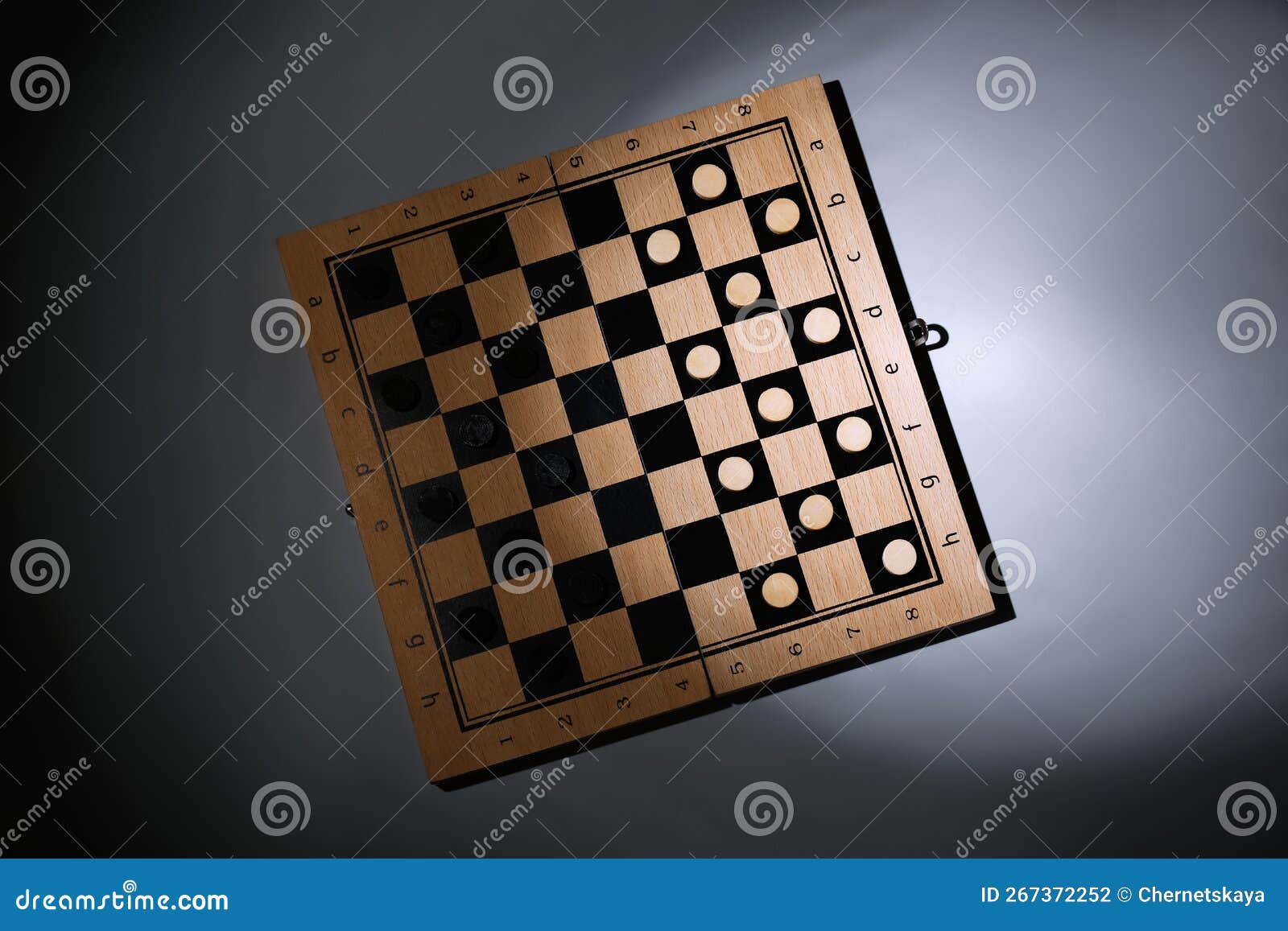 Wooden Checkerboard with Game Pieces on Grey Background, Top View Stock ...
