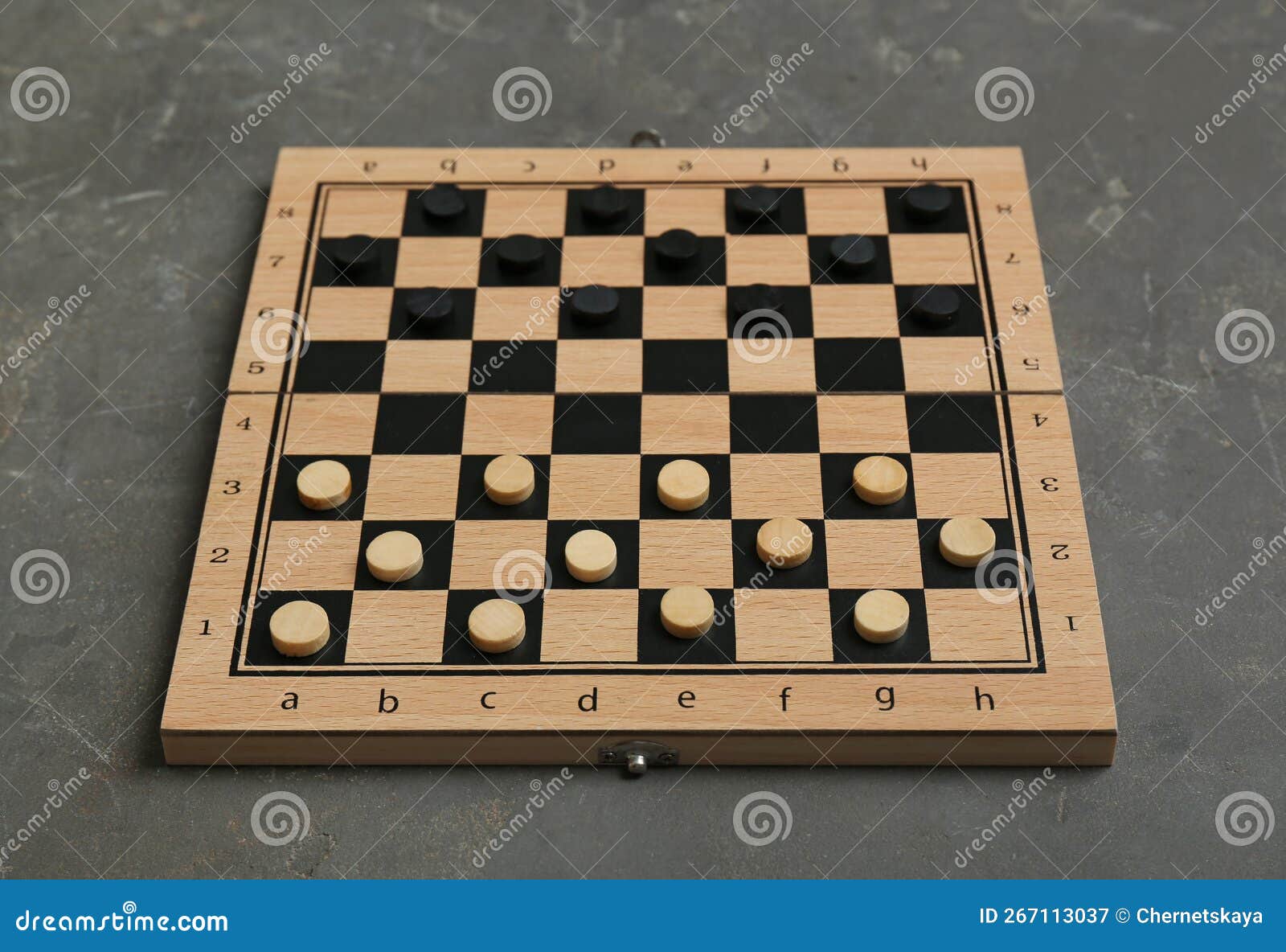 Wooden Checkerboard with Game Pieces on Grey Table Stock Image - Image ...