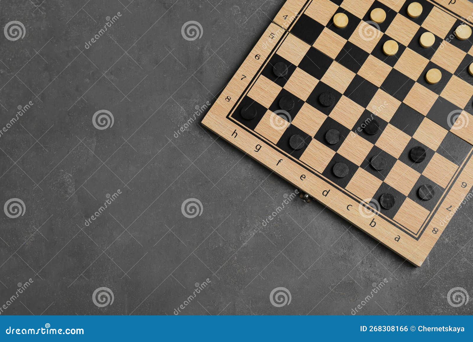 Wooden Checkerboard with Game Pieces on Grey Table, Top View. Space for ...
