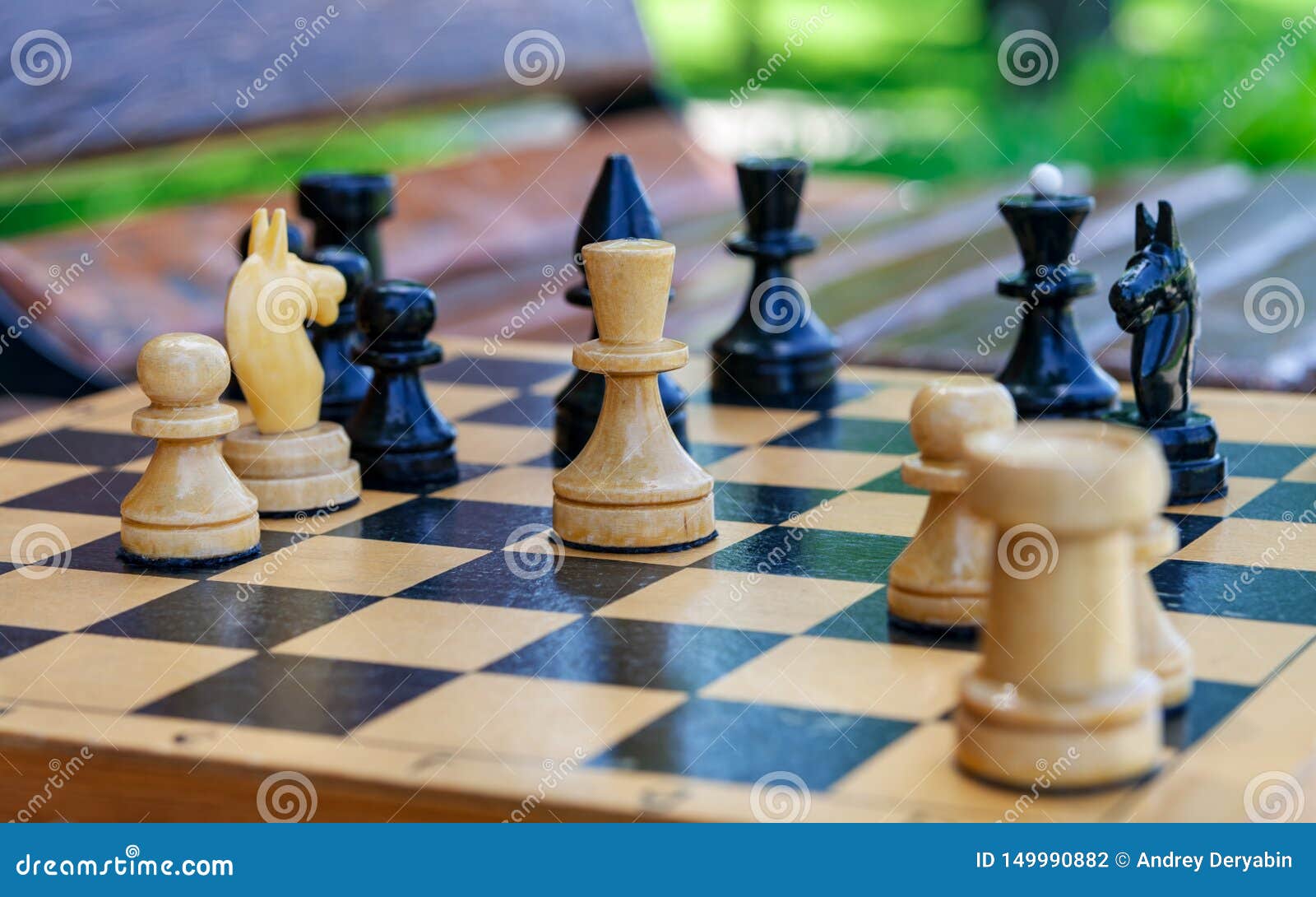 Wooden chess on the bench. stock photo. Image of park - 149990882
