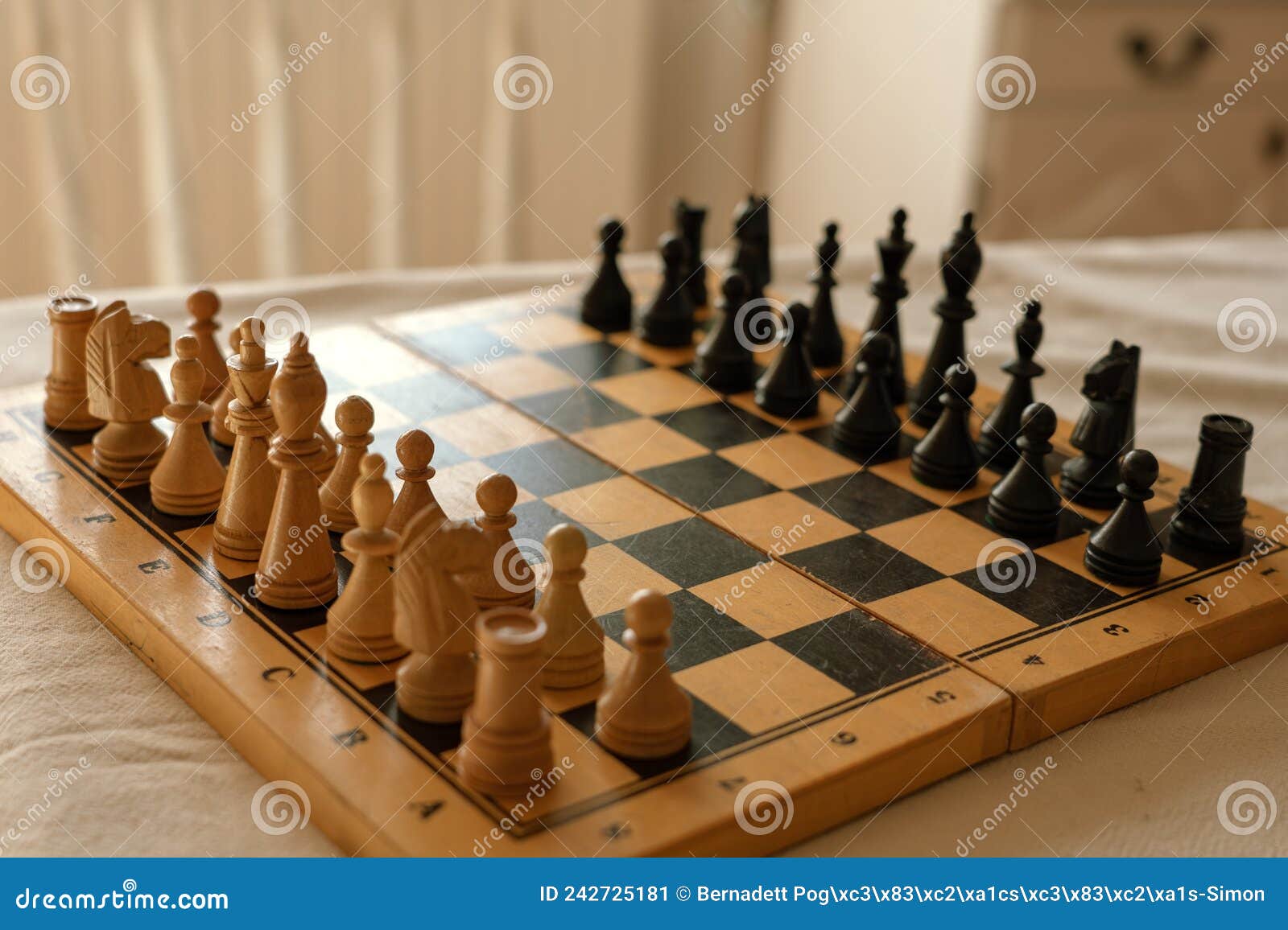 Wooden Chess Figures Standing in a Row on an Old Chess Board Beginning ...