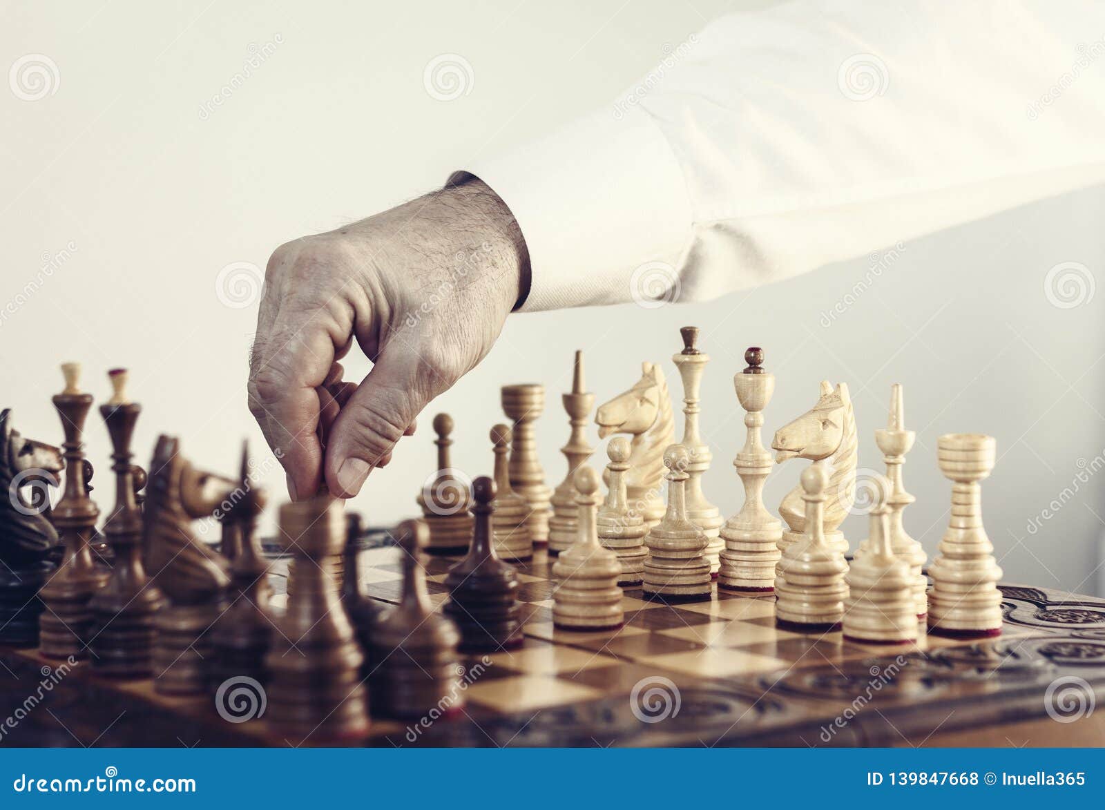 Wooden Chess Pieces on a Chessboard, Chess Game Player Makes a Move ...