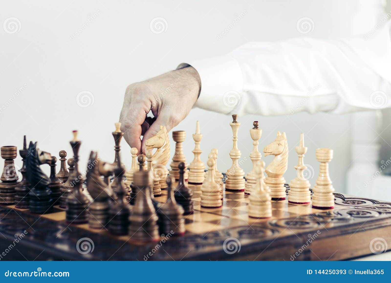 Wooden Chess Pieces on a Chessboard, Chess Game Player Makes a Move ...
