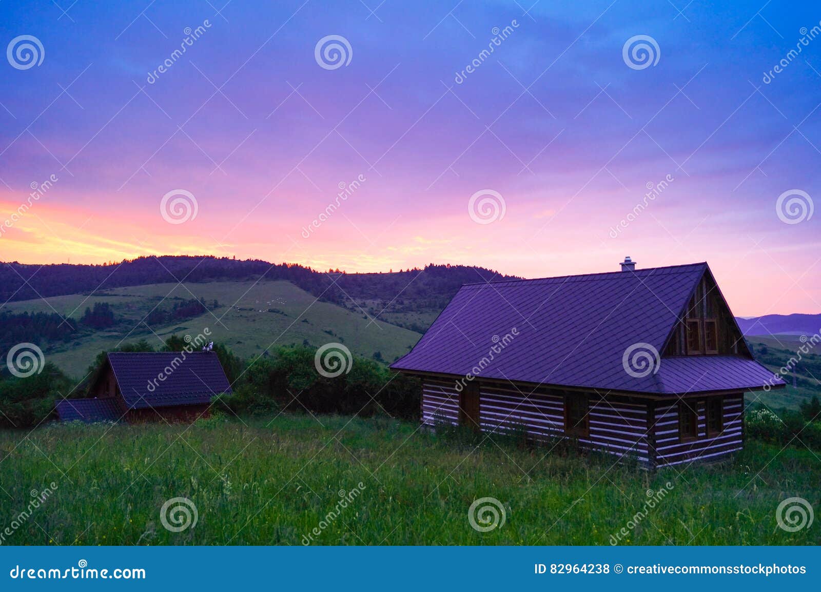Wooden Cottage In Field At Sunset Picture. Image: 82964238