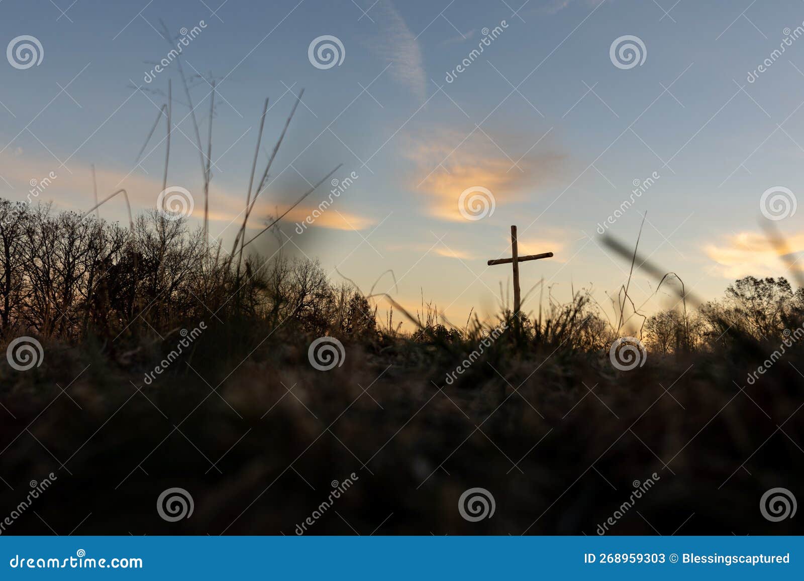 A wooden cross at sunrise stock image. Image of field - 268959303