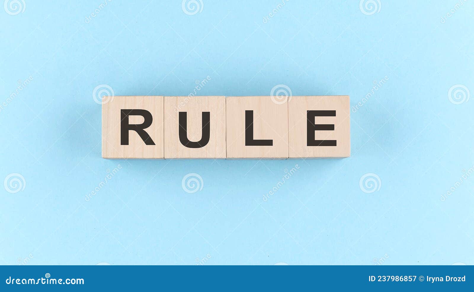 Wooden Cube Block with Text RULE on the Blue Background Stock Image ...