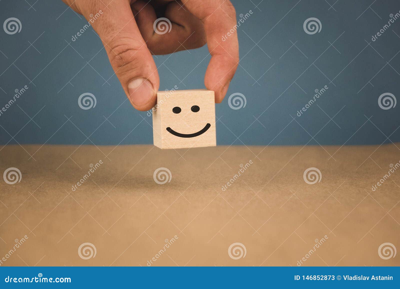 Wooden Cube and the Image of a Smiling Smiley that is in Person`s Hand ...