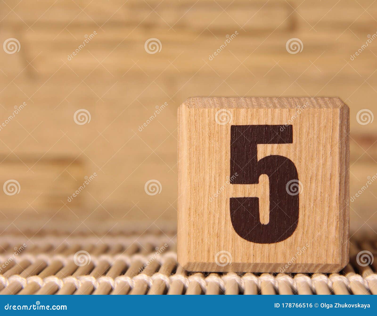A Wooden Cube with the Number Five on a Beige Background Stock Photo ...