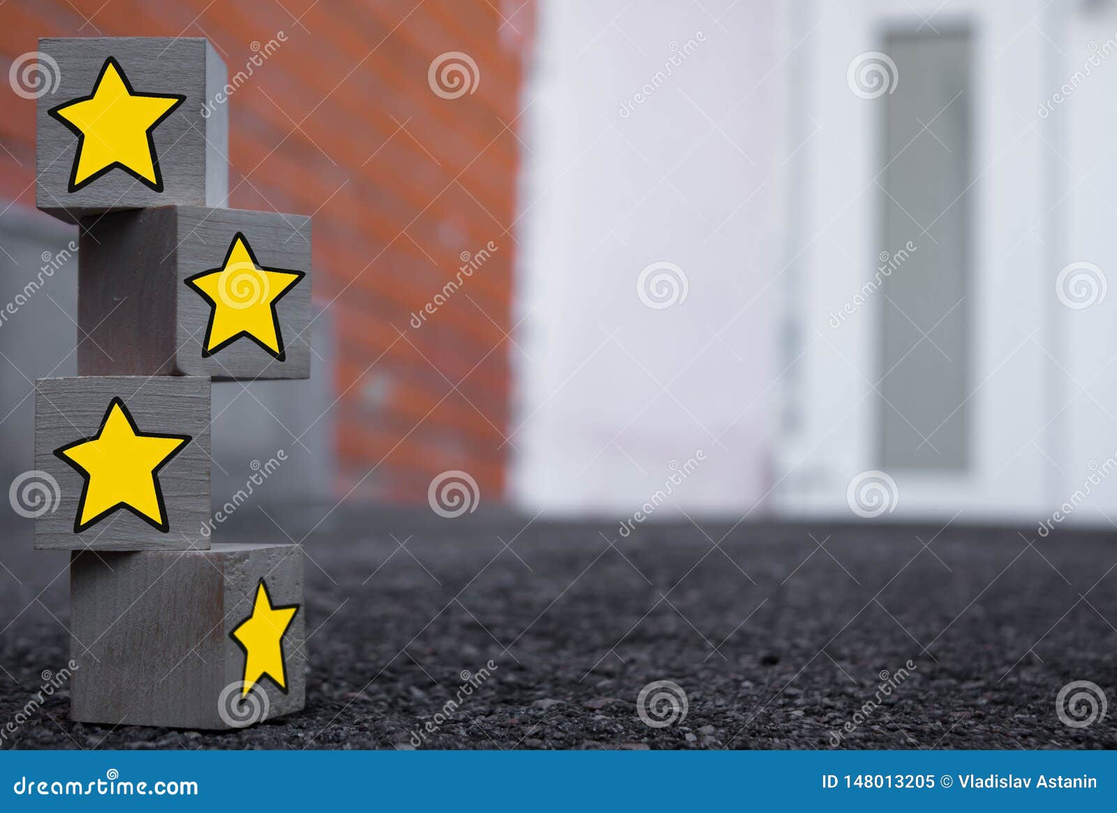 4 Wooden Cubes with a Pattern of a Yellow Star Standing on Top of Each ...