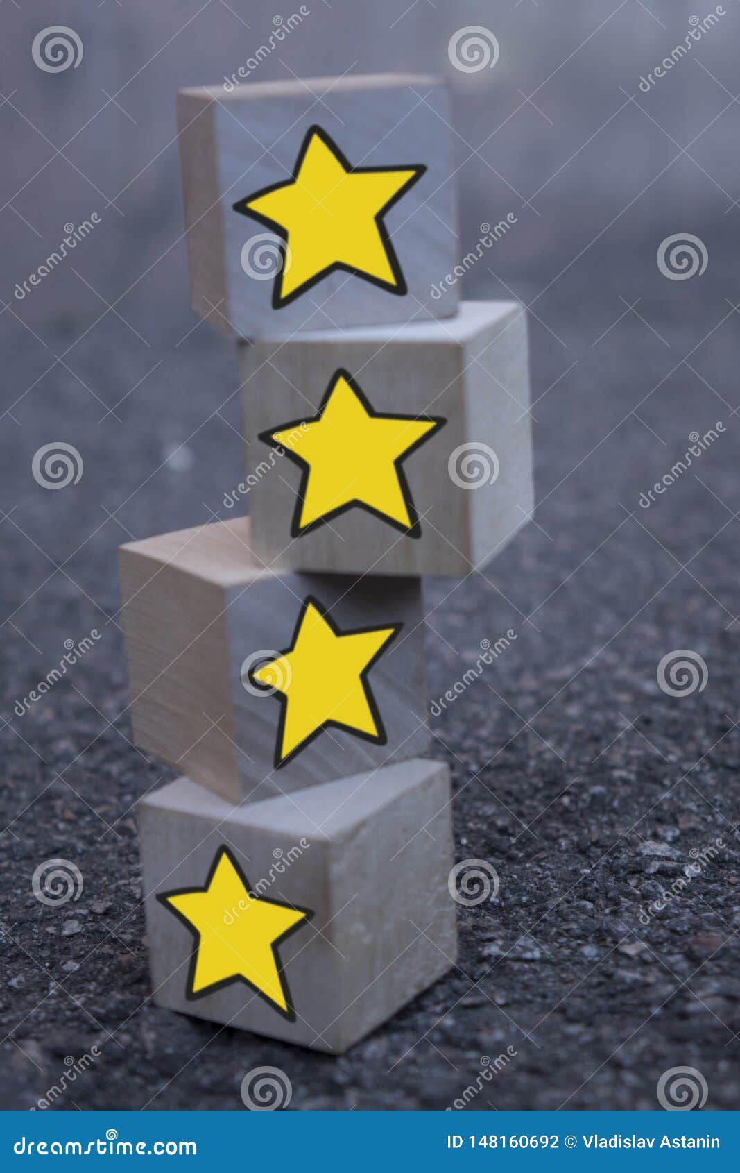 4 Wooden Cubes with a Pattern of a Yellow Star Standing on Top of Each ...