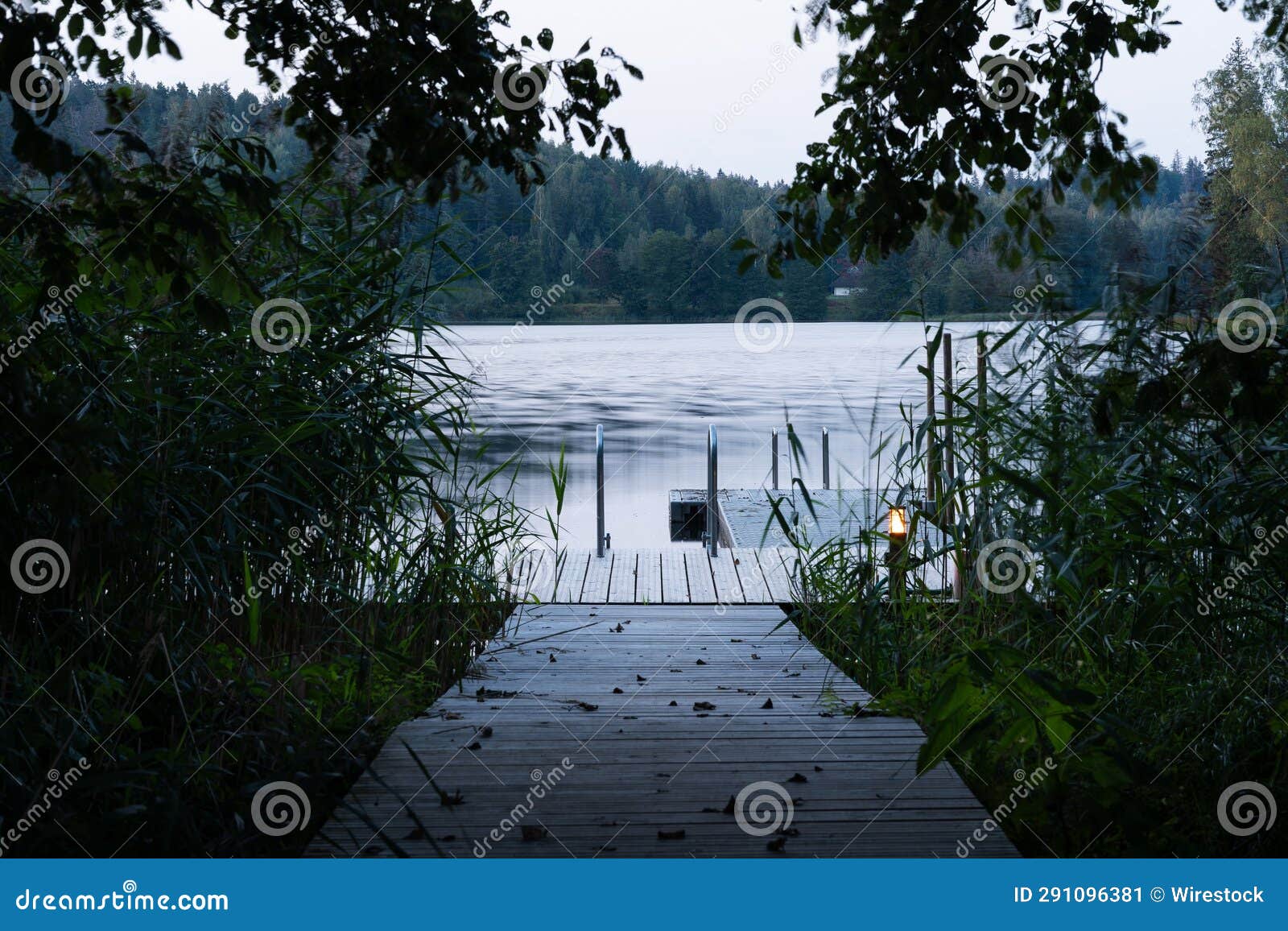 Wooden Deck Overlooking a Scenic Lake Surrounded by Lush Greenery Stock ...