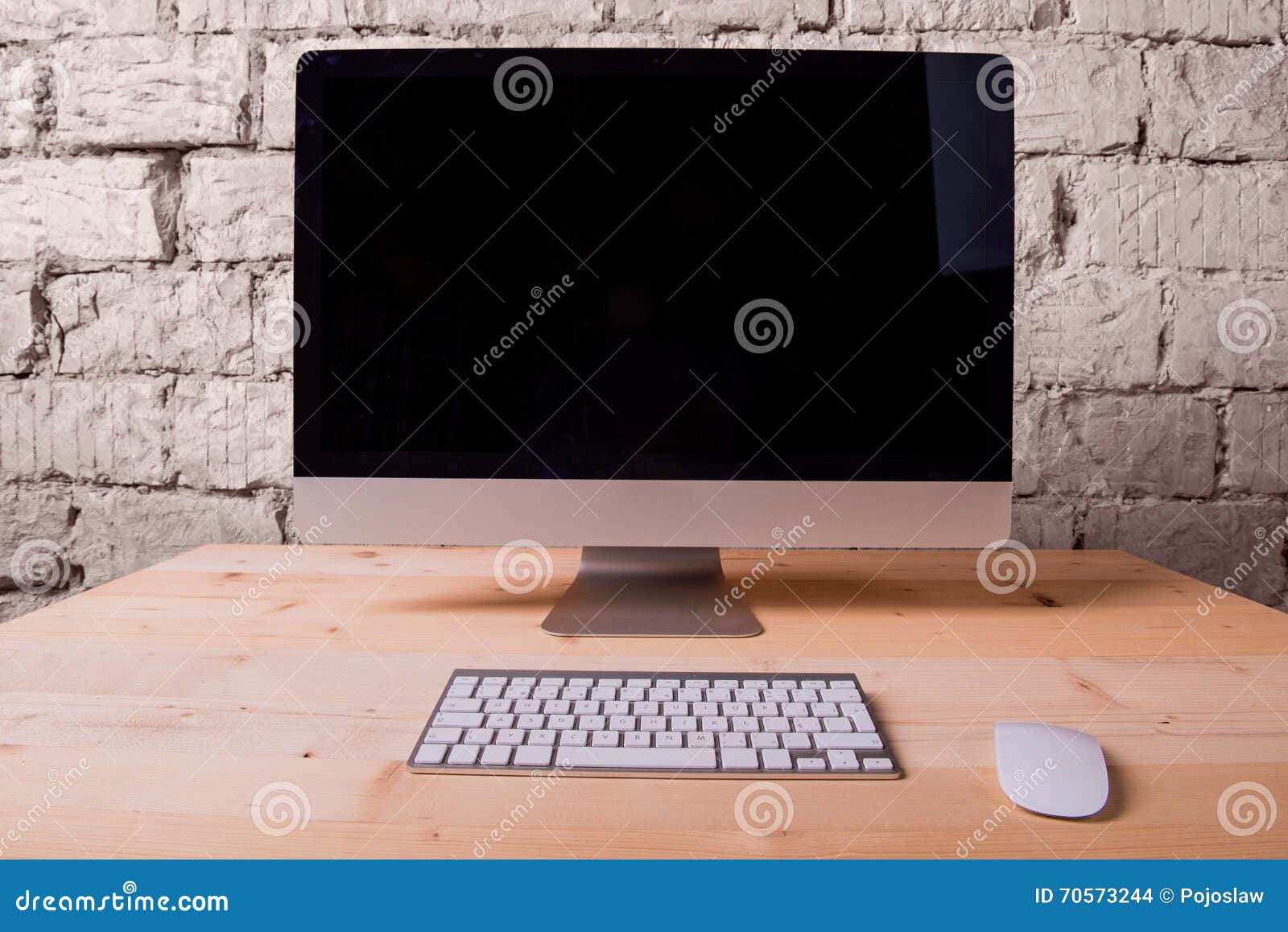 Wooden Desk with Computer, Keyboard and Mouse. Brick Wall. Stock Photo ...