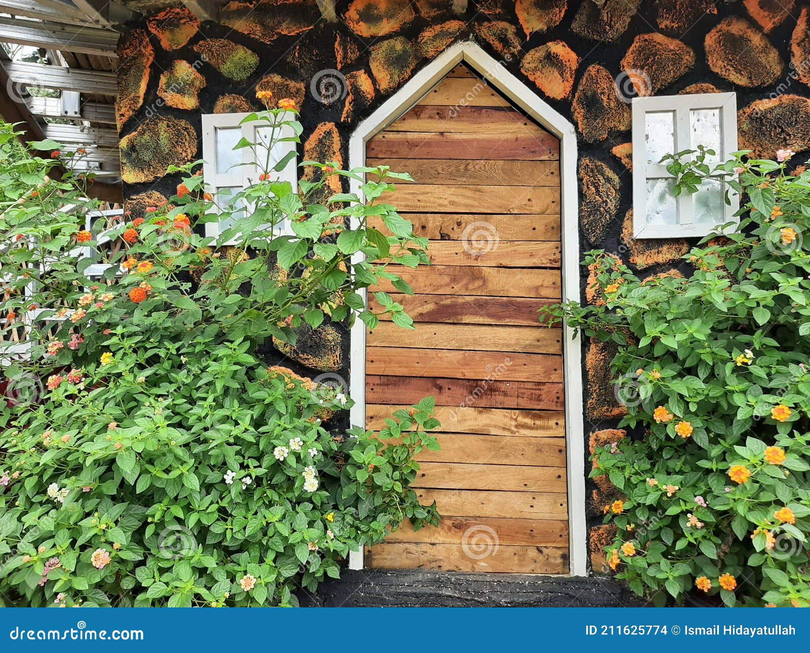 Wooden Doors in a Beautiful Flower Garden Stock Photo - Image of ...