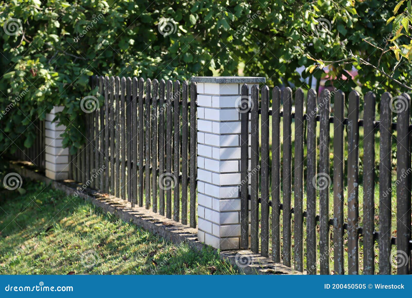 Wooden Fence with a Brick Pole in a Garden Stock Image - Image of wall ...