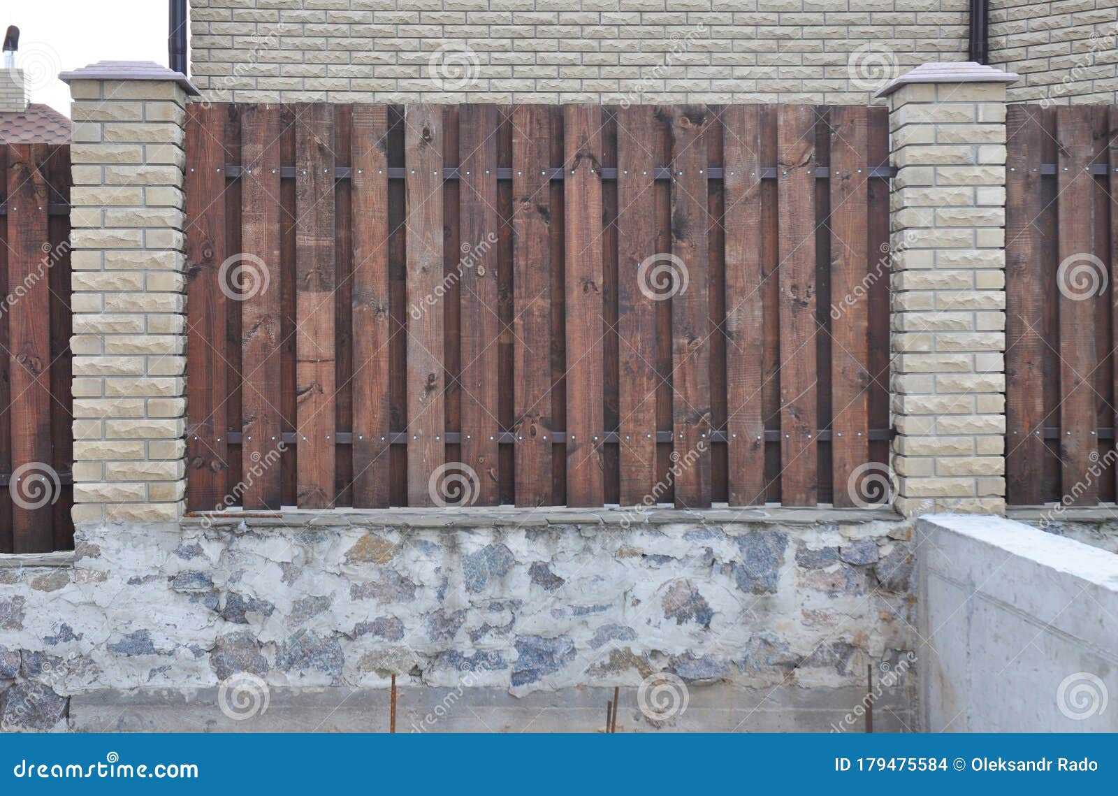 A Wooden Fence Design with Brick Support Pillars and Brick Foundation ...