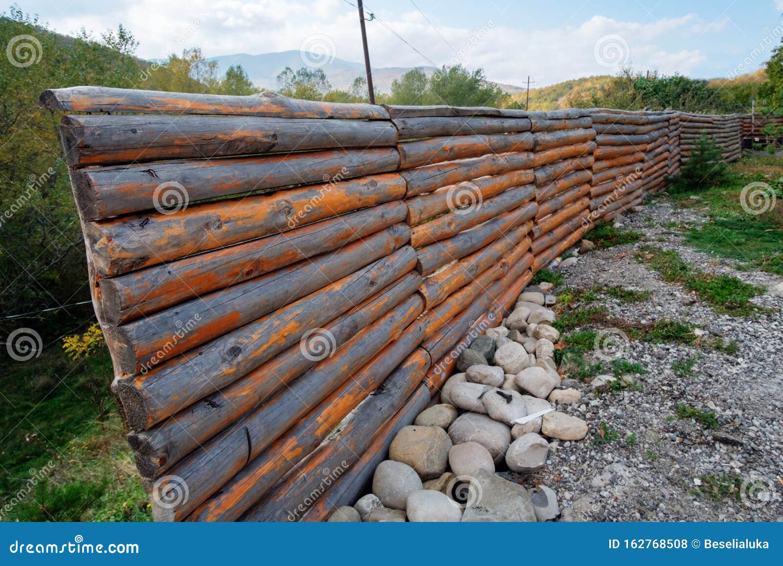 Wooden fence made of logs stock photo. Image of autumn - 162768508