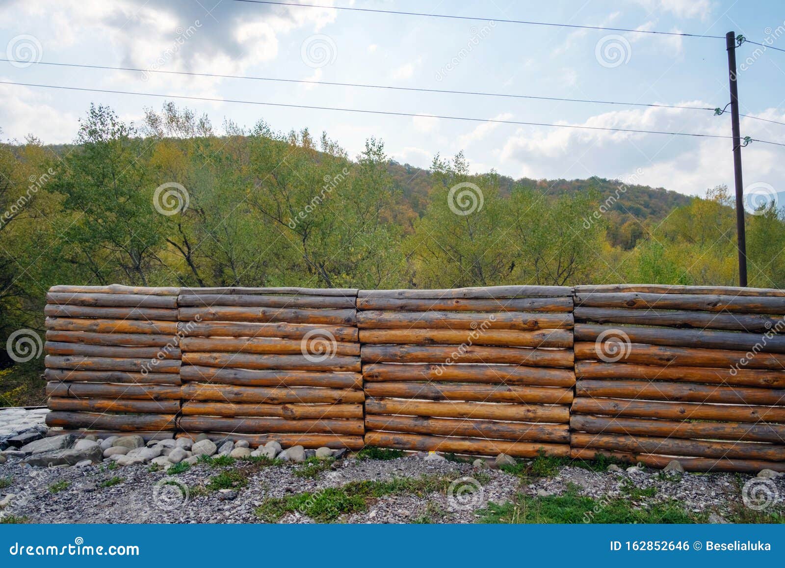 Wooden fence made of logs stock photo. Image of rural - 162852646